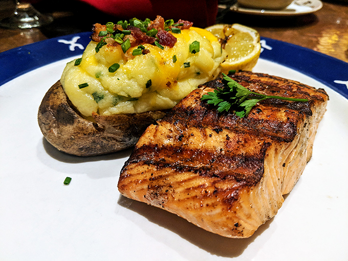 Salmon grilled to that magical point where flaky meets juicy, accompanied by a loaded baked potato that's practically a meal unto itself.