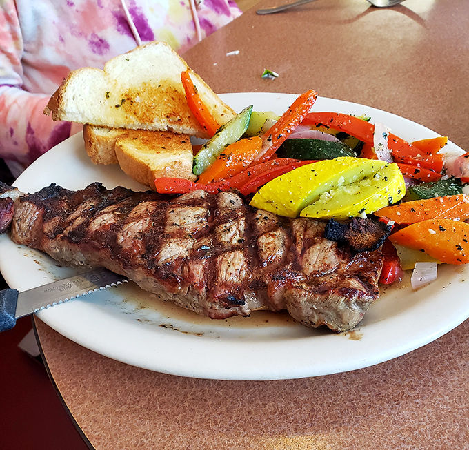 Even in a seafood haven, this perfectly grilled steak with vibrant vegetables proves the kitchen's versatility extends beyond the ocean.