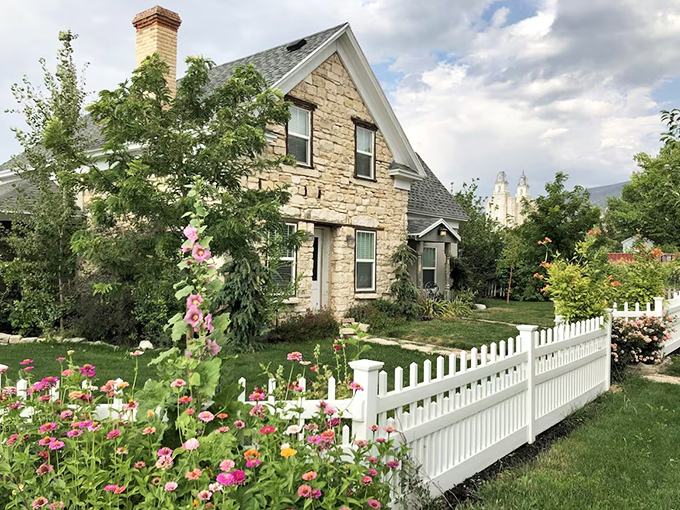 White picket fences and hollyhocks frame this pioneer stone home &ndash; it's not just a house, it's a picture-perfect slice of Americana.