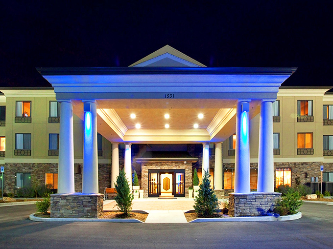 Holiday Inn Express glows with welcoming blue light, promising a comfortable bed and the simple pleasure of someone else making breakfast.