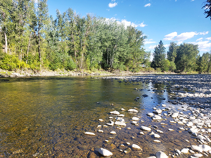 Crystal clear waters flow over smooth river stones, creating nature's own meditation soundtrack in this pristine corner of the Methow Valley.