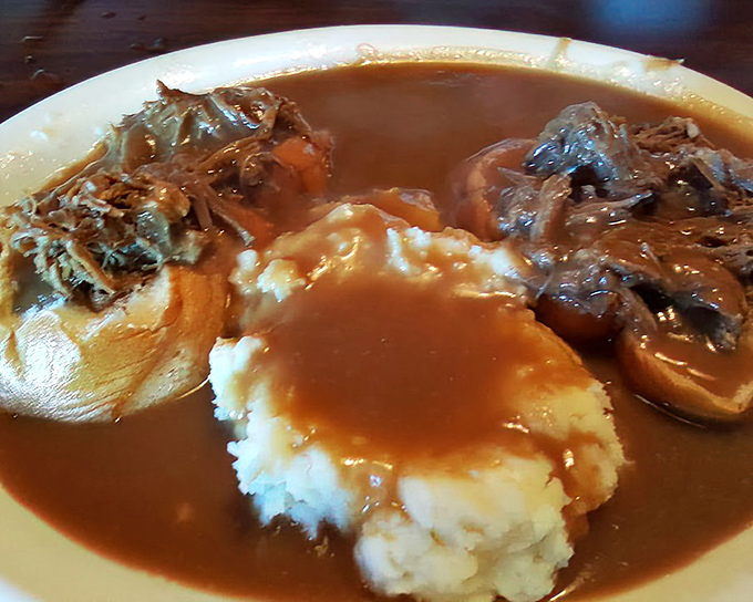 The hot beef sandwich&mdash;where gravy isn't just an addition, it's a full-fledged commitment to comfort food excellence.