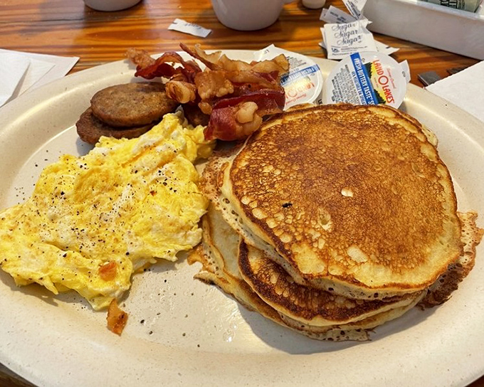 A hungry man breakfast featuring pancakes, eggs, bacon, and sausage that laughs in the face of portion control everywhere.
