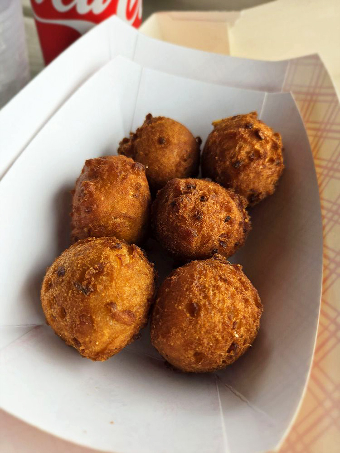 Hush puppies so good they deserve their own fan club. These golden orbs of cornmeal joy are what happens when fritters achieve their highest purpose.