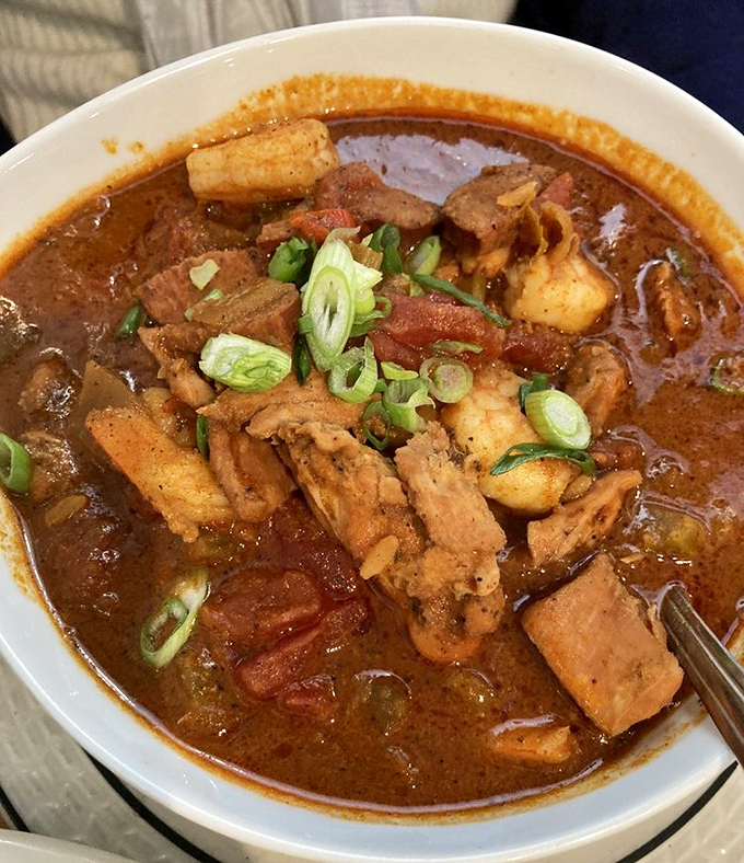 This isn't just stew—it's a spicy, soul-satisfying bowl of everything right with the world. Green onions floating like flavor lifeboats in a sea of goodness.