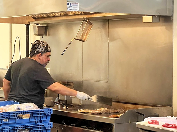 Behind the scenes, the grill master works their magic, turning simple ingredients into memories worth driving for.