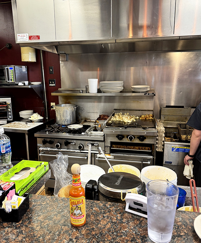 Behind the scenes in the kitchen, where simple ingredients transform into extraordinary comfort food. That bottle of Cholula hints at the thoughtful touches that elevate diner classics.