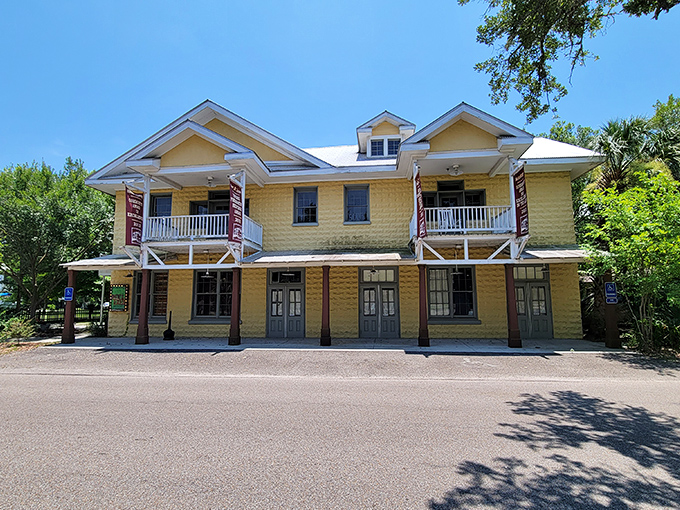 The historic Little Theatre's sunny yellow facade invites cultural exploration. Where community drama happens on stage, not just at town meetings.
