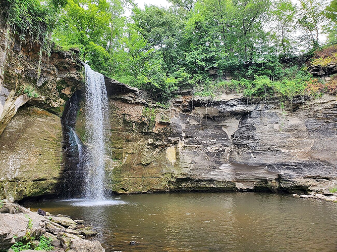 Lower Minneopa Falls plunges dramatically into a serene pool, carving its story into ancient limestone one drop at a time.