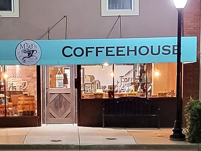 M&J's Coffeehouse glows like a beacon for caffeine-seekers, its warm interior light spilling onto brick sidewalks as evening settles over downtown Augusta. 