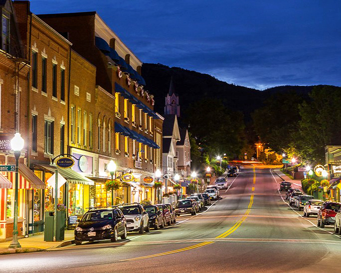 As night falls on Main Street, the warm glow of shop windows creates the perfect backdrop for an after-dinner stroll.