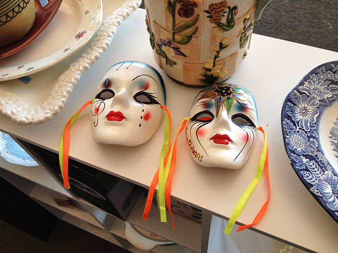 Porcelain masks that once adorned walls now wait silently for their next performance. Drama for less than dinner and a show.