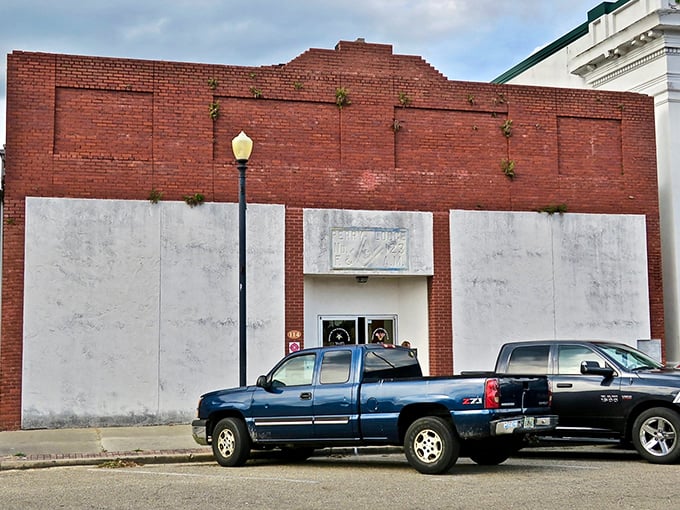 This weathered brick building with boarded windows tells the honest story of small-town America—not every structure survives, but its bones remain dignified.