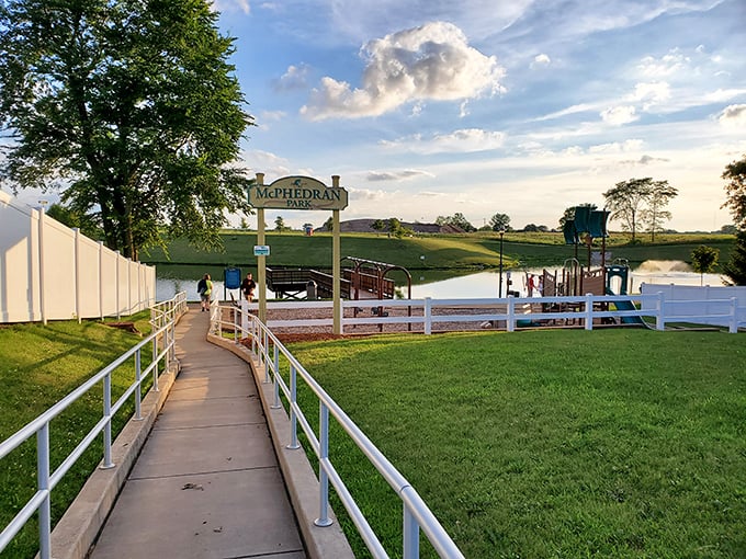 McPhedran Park's waterfront walkway leads to summer fun, where families gather for swimming, picnics, and sunset watching.