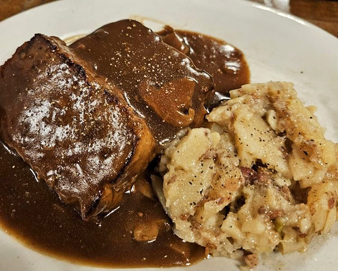 Meatloaf swimming in rich gravy alongside German potato salad. Comfort food that makes you want to call your mother and apologize for ever complaining.