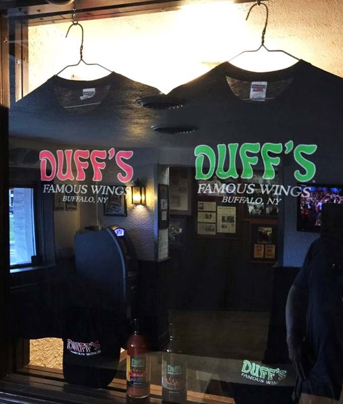 Duff's merch: because sometimes you need proof you survived the "hot" wings. The t-shirt as both souvenir and badge of courage.