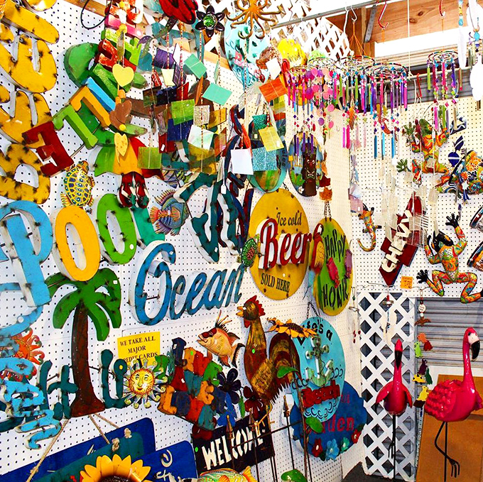 Beach vibes materialize in metal and color! This wall of coastal-themed decor transforms "tacky tourist" into "delightfully Floridian" with surprising charm.