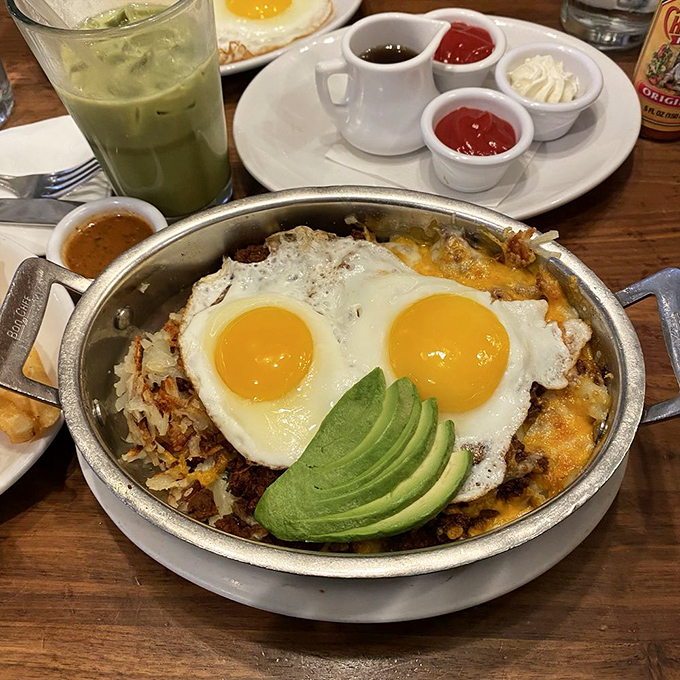 This skillet is what happens when breakfast decides to dress for a fiesta. Those sunny-side-up eggs are wearing avocado sombreros!