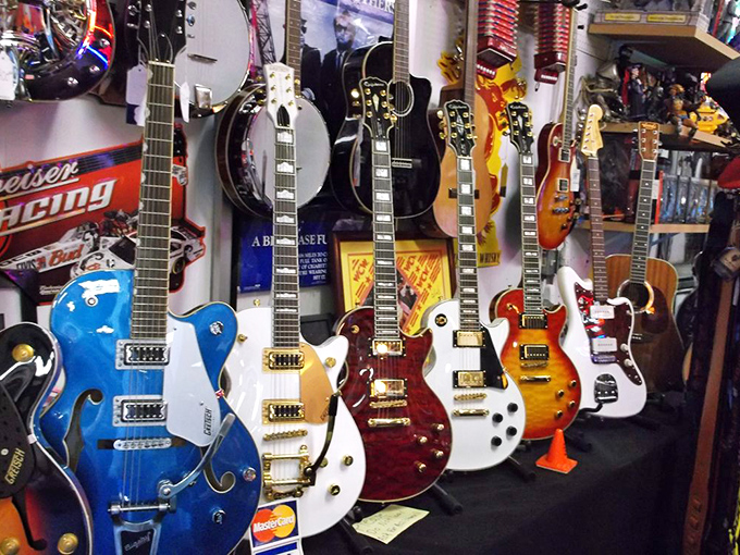 Guitar gallery that makes musicians weak at the knees. Each instrument hangs like a promise of blues riffs and rock solos yet to be played.