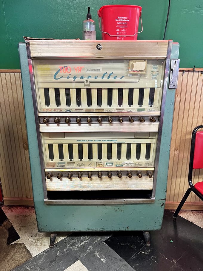 A vintage cigarette machine stands guard like a museum piece, reminding us how much times have changed (thankfully).