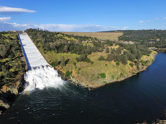 The spillway cascades with the kind of power that makes you appreciate both engineering marvels and a safe viewing distance.