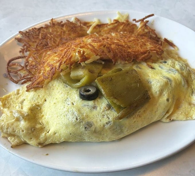 This isn't just an omelet &ndash; it's a golden envelope of egg perfection, stuffed with treasures and accompanied by a crown of crispy hash browns.
