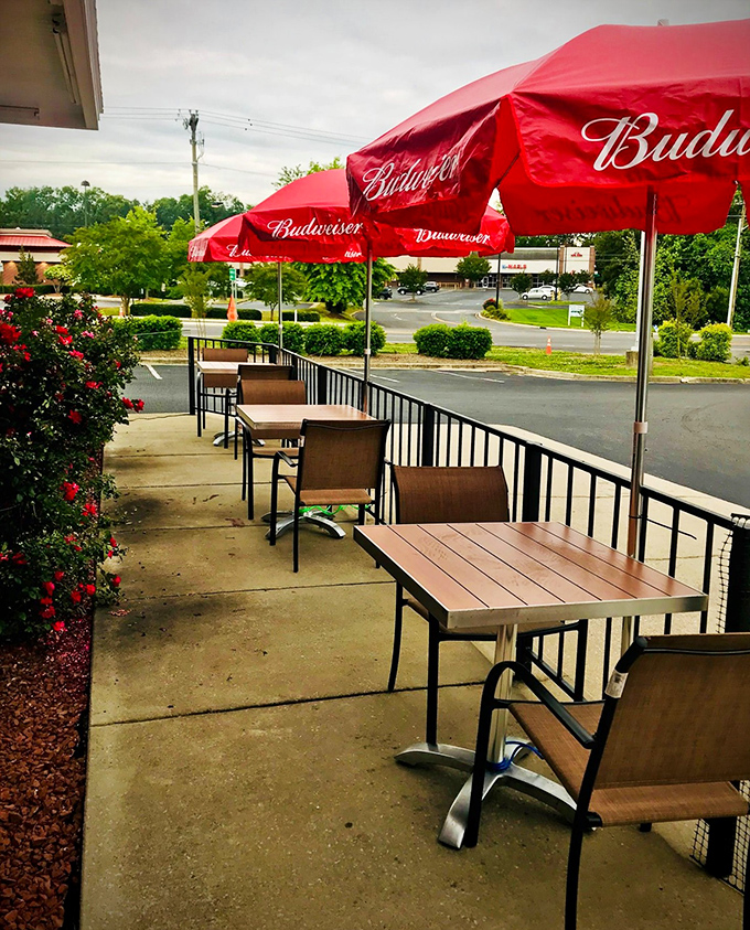The outdoor patio where sweet tea tastes even sweeter under Budweiser umbrellas. Southern summer dining at its most authentic.