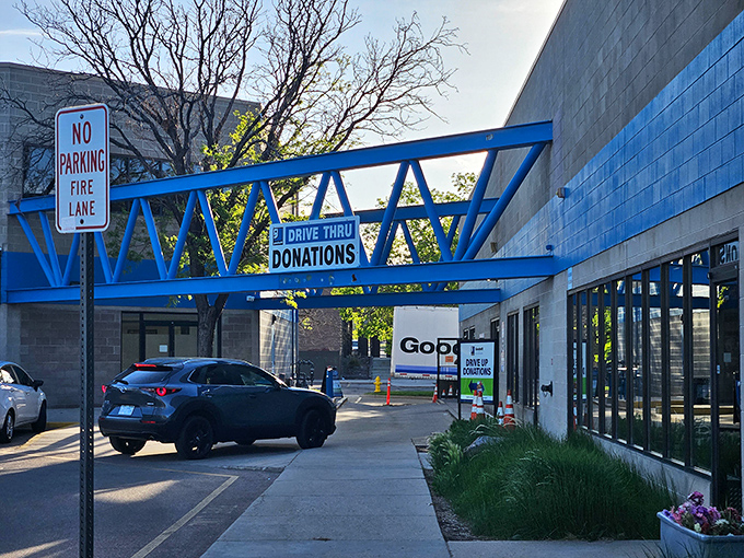 Blue architectural elements frame the entrance like a portal to a parallel universe where shopping and sustainability perfectly align.