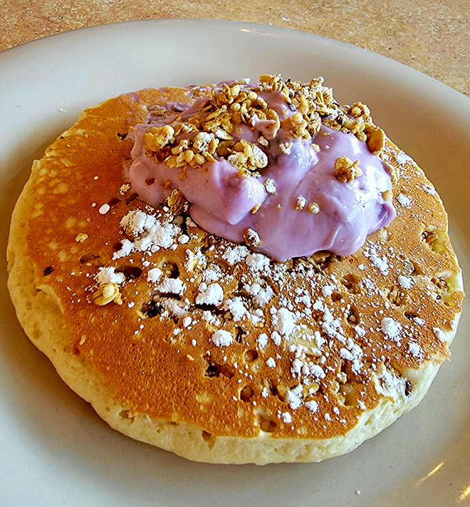 Not just a pancake, but a canvas &ndash; painted with berry yogurt, sprinkled with granola, and dusted with powdered sugar for breakfast artistry.