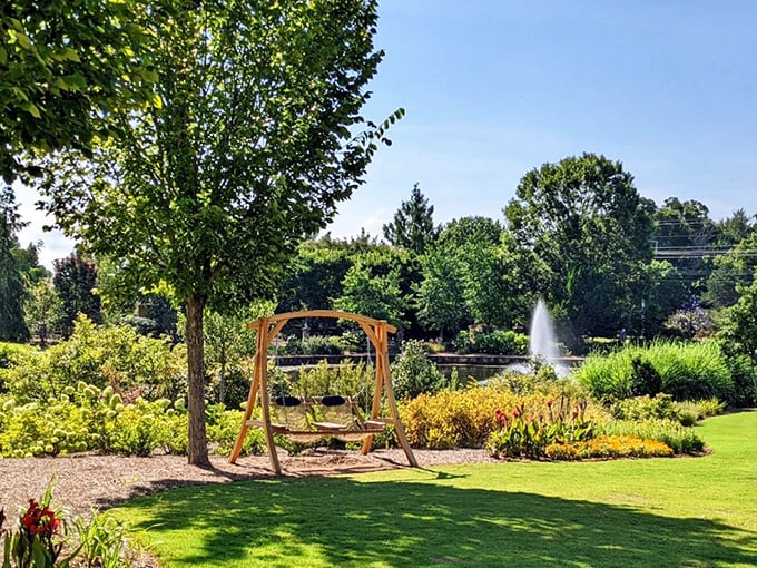 A garden swing positioned for maximum serenity &ndash; because sometimes the best way to enjoy nature is while gently swaying with a view of everything.