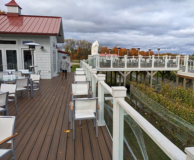 The elevated deck invites lingering conversations while vineyards and autumn colors provide nature's entertainment below.