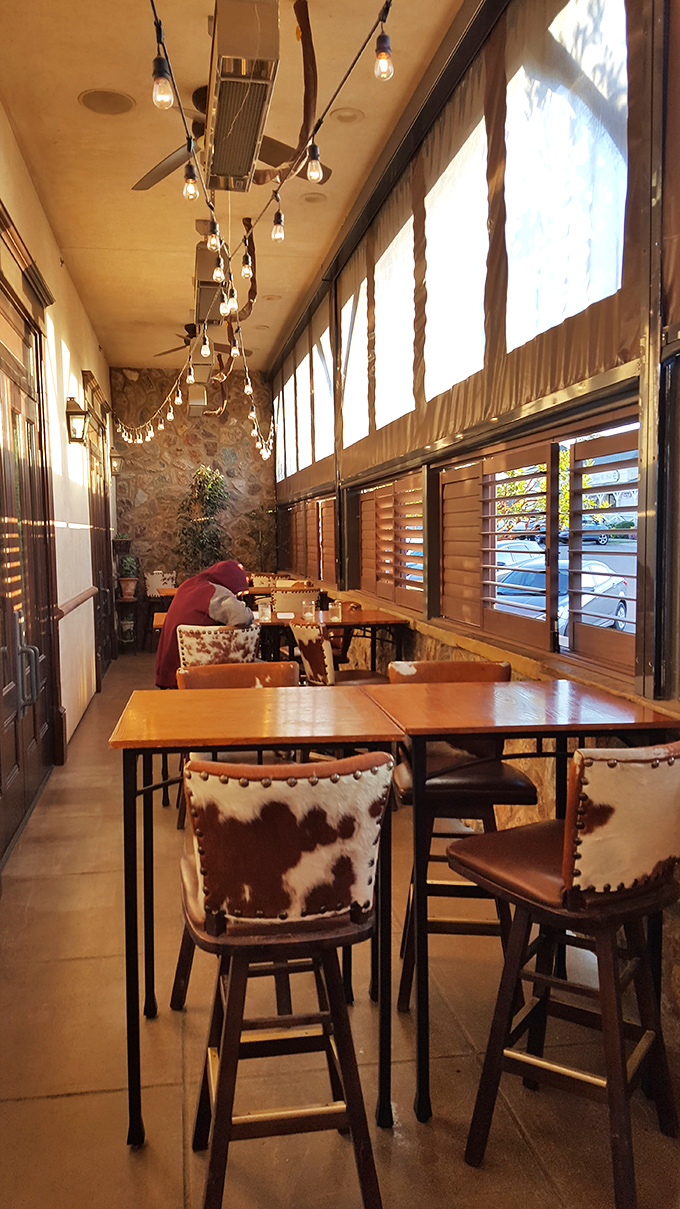 String lights and cowhide chairs make this patio seating area feel like the world's most comfortable ranch. Casual elegance defined.