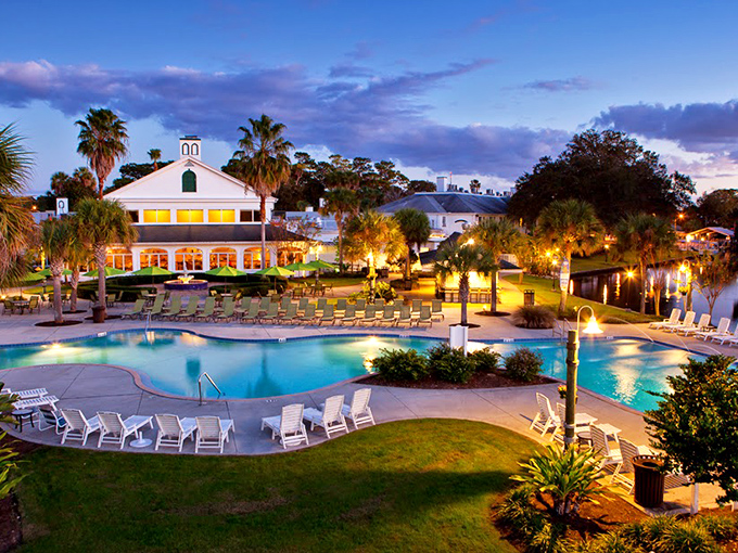 Plantation Inn's evening glow transforms its pool into a luminous oasis, where palm trees stand sentinel over your perfect Florida evening.