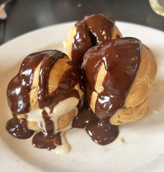 Profiteroles dripping with chocolate that doesn't just satisfy your sweet tooth&mdash;it throws a party for it. Cream puffs living their best life.