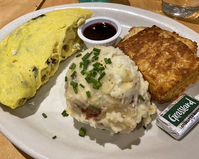 Breakfast of champions: fluffy omelet, potato perfection, and a biscuit that would make a Southern grandmother weep with joy.