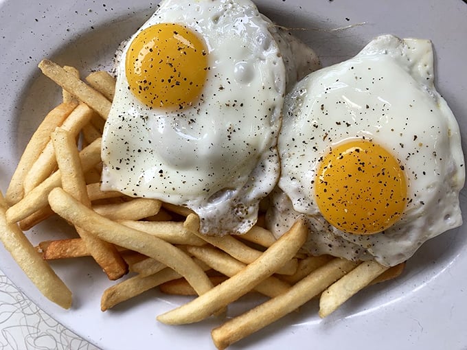 Eggs sunny-side up with golden yolks that pop like tiny suns. Proof that sometimes the simplest dishes require the most skill to perfect.