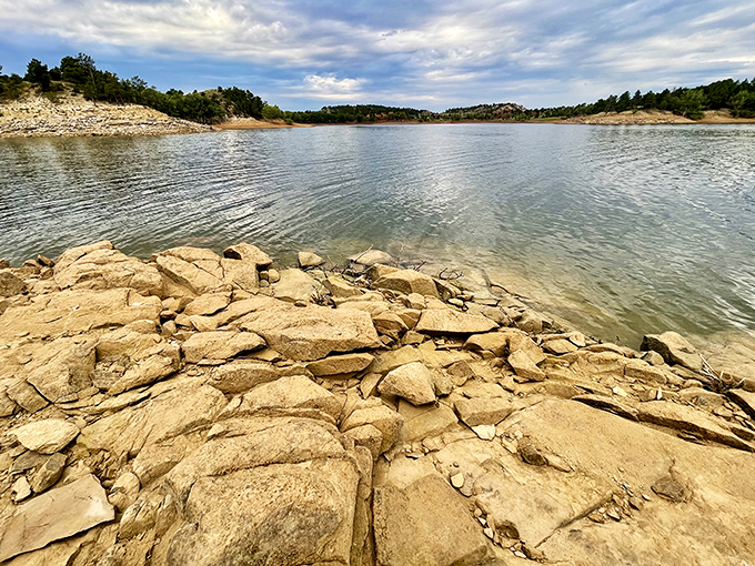Nature's jigsaw puzzle of sun-warmed stones meets cool, clear water. No assembly required, just pure appreciation.