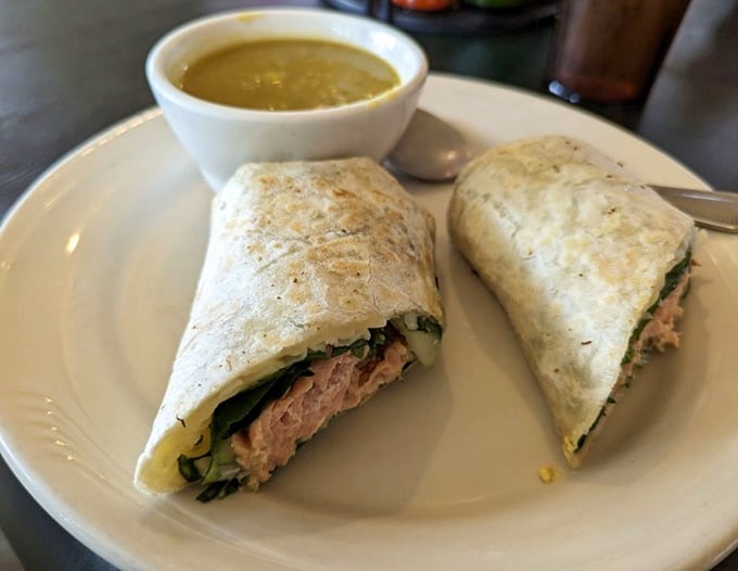 This salmon wrap with its side of golden soup isn't just lunch – it's an edible argument for extending your stay in Red Lodge.
