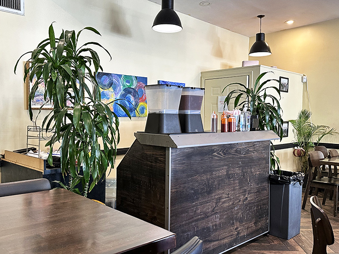 Lush plants frame the drink station, bringing a touch of greenery to complement the earthy, soulful flavors that define this beloved eatery.
