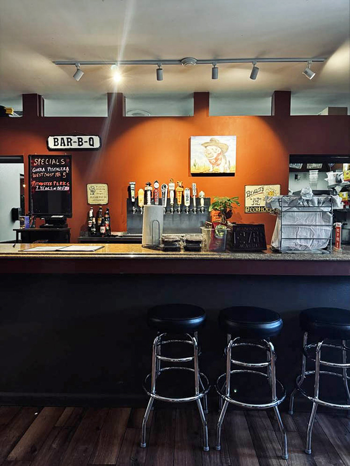 The bar's orange wall provides a sunset backdrop for taps ready to quench the thirst that good barbecue inevitably creates. Barbecue math: spicy food + cold beer = perfection.