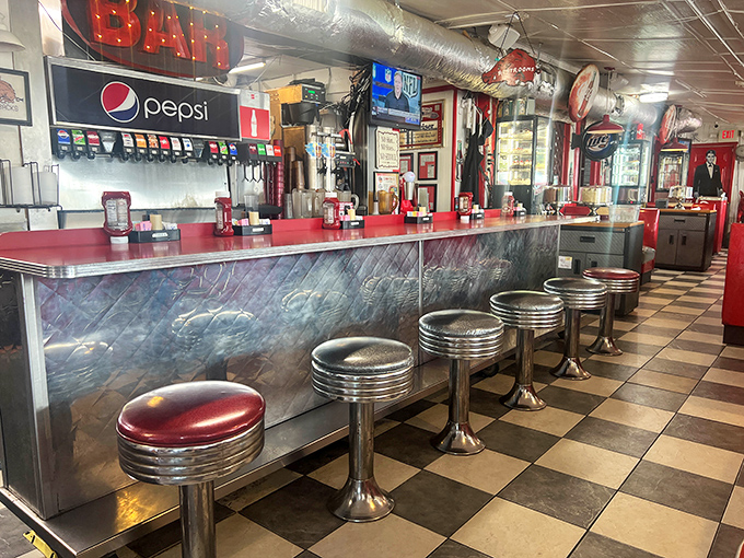 The neon-lit bar area serves up cold drinks and nostalgia in equal measure &ndash; no fancy mixologists, just honest pours.
