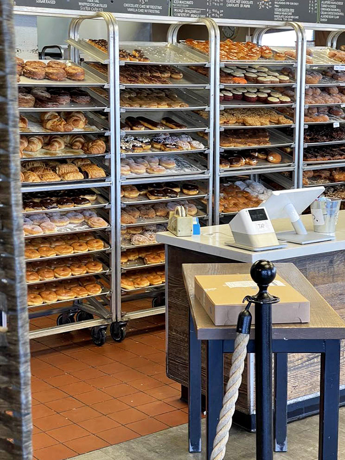 Rolling racks positioned near checkout ensure last-minute additions, because willpower crumbles faster than these flaky pastries do.