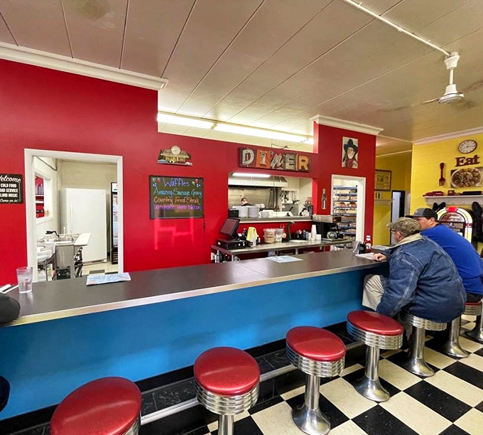 The counter where breakfast dreams come true, complete with classic red stools that have supported generations of satisfied diners.