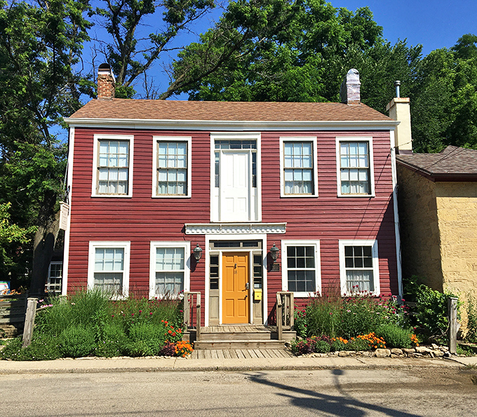 This vibrant red clapboard building with its cheerful yellow door invites you into Shake Rag Alley, where creativity has found a historic home.