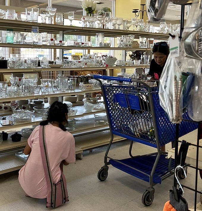 The serious business of glassware hunting. These shoppers know that patience and a keen eye are the secret ingredients to thrifting success.