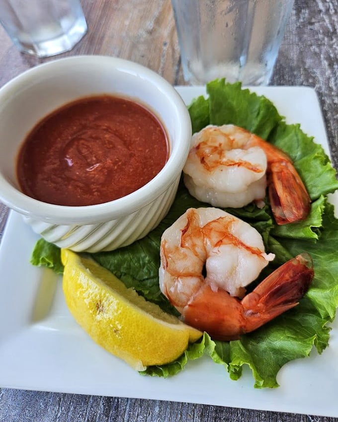 Plump shrimp perched on crisp lettuce with zesty cocktail sauce – simplicity that lets the seafood shine.