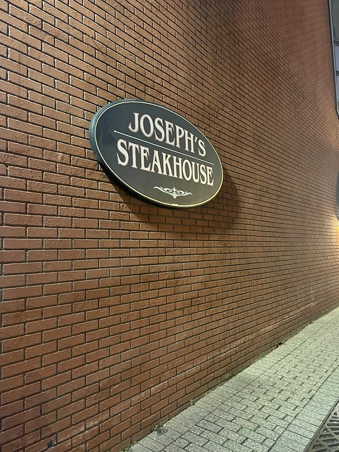 The oval sign on brick&mdash;simple, understated, confident. No flashy gimmicks needed when what's inside speaks for itself.