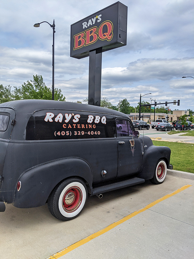 That vintage delivery truck beneath the Ray's BBQ sign isn't just transportation &ndash; it's a time machine delivering smoky goodness across Norman. 