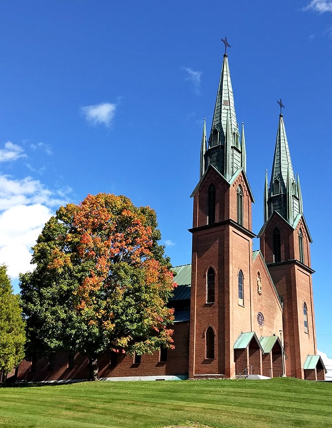 St. Francis Xavier Church towers beautifully against autumn colors, its twin spires reaching skyward with architectural confidence and grace. 