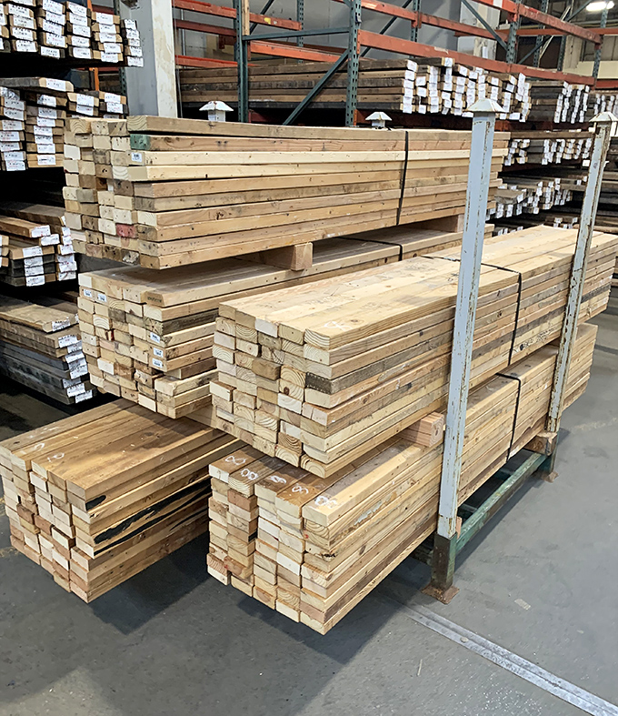 Stacked lumber reaching skyward like a woodworker's version of skyscraper construction, ready for your next big building project.